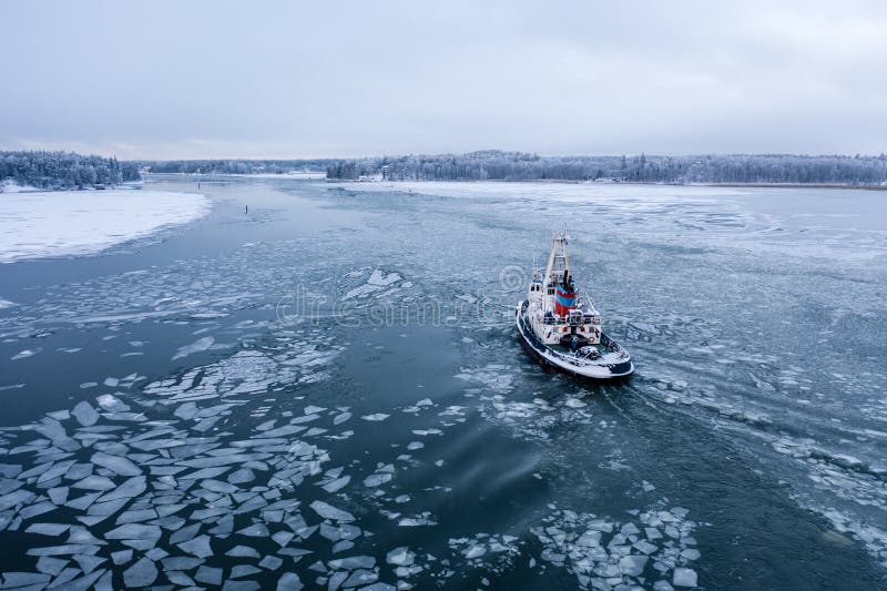 Tug Boat Pushing through the Ice on a Sea in Winter Stock Photo - Image ...