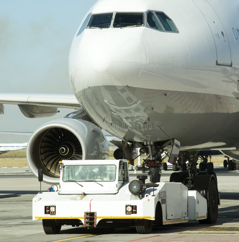 Tug moving a jet aircraft stock photo. Image of airport - 51530790