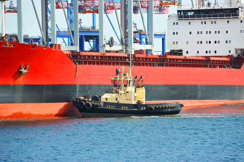 Tugboat Assisting Bulk Cargo Ship Stock Photo - Image of maritime ...