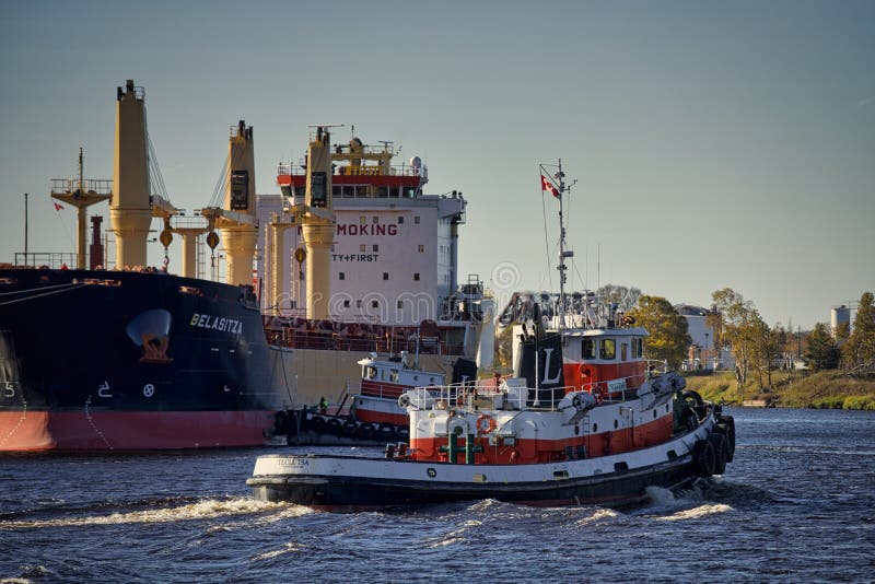 Tugboat Assisting an Ocean-going Vessel in the Port of Thunder Bay ...