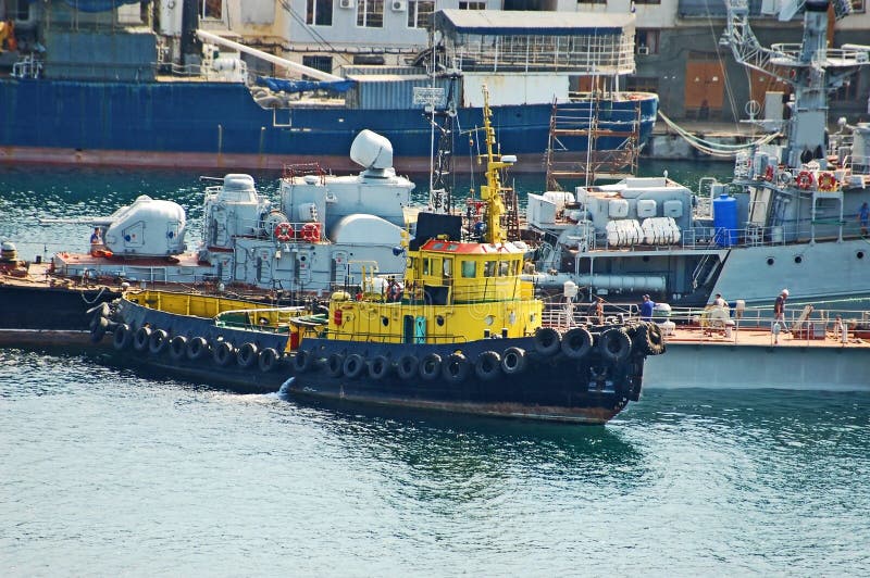 Tugboat at Military Ship at Harbor Stock Image - Image of pier, patrol ...
