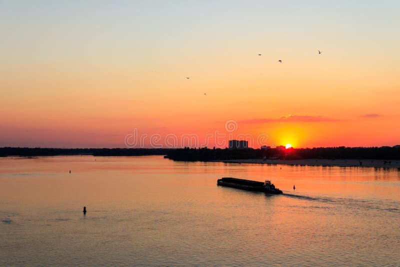 Tugboat Pushing a Heavy Long Barge on River Dnieper at Sunset Stock ...