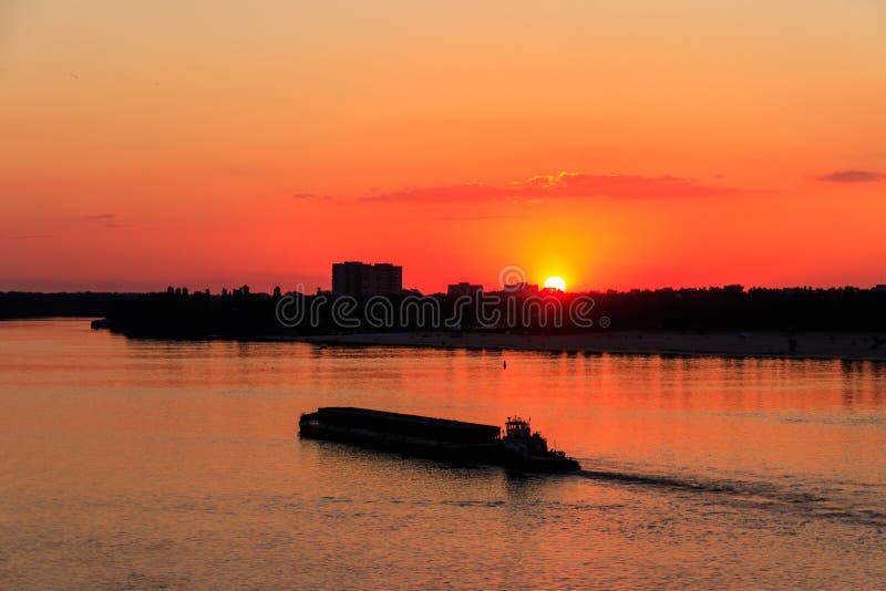 Tugboat Pushing Heavy Long Barge on the River Dnieper at Sunset Stock ...