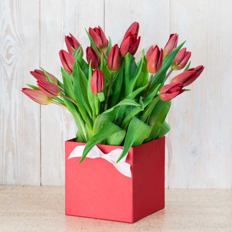 Gift Box With Tulips And Herbs And Engagement Rings On Wood Wa Stock ...