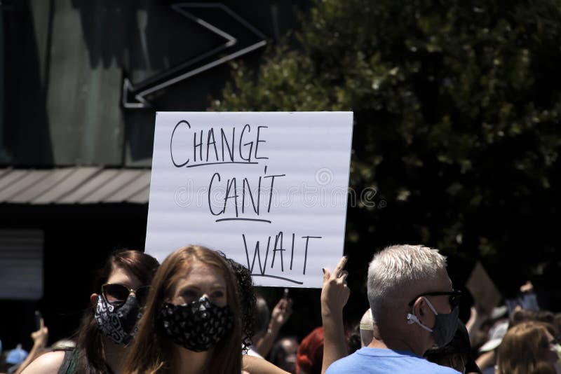 Change Can`t Wait Sign at BLM Protest with Blurred Protesters Around it ... Change Can`t Wait Sign at BLM Protest with Blurred Protesters Around it ...