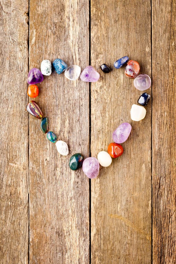 Tumbled Healing Crystals in Heart Shape on Wooden Background Stock ...