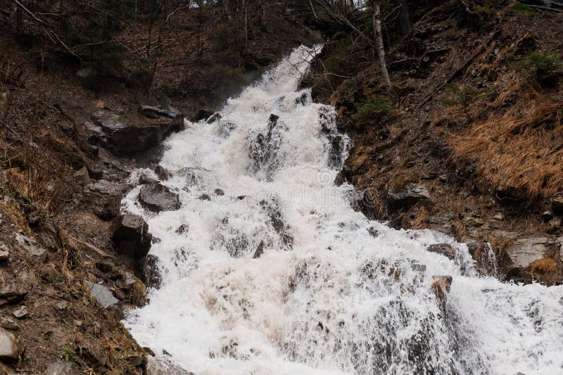 Tumultuous Mountain Waterfall Cascading through Rugged Terrain Stock ...