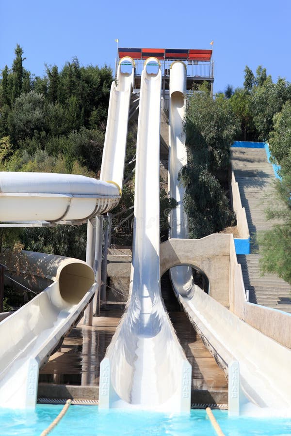 Boy on water slide stock photo. Image of resort, holiday - 128770544