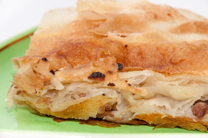 Turkish Burek with Meat on a Green Plate with Fork and Knife Stock ...