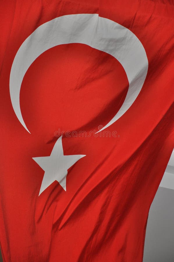 The Turkish Flag Flies in the Wind on Flagpole Against the Blue Sky and ...