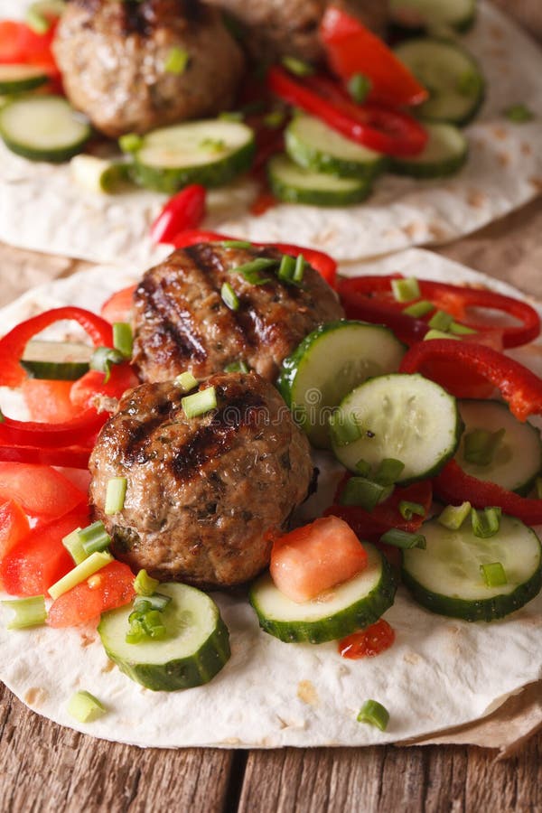 Turkish Kofta with Fresh Vegetables on a Flat Bread Close Up. Vertical ...