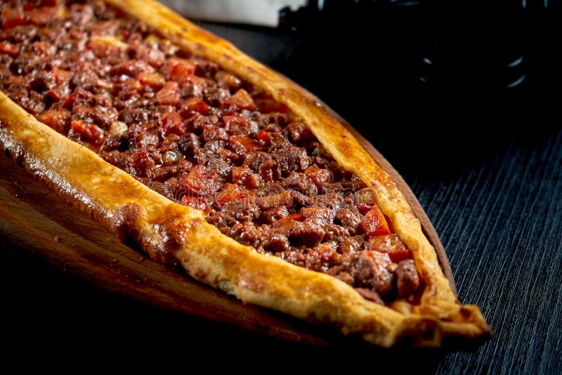 Turkish Pide Dish with Slices of Beef, Tomatoes on Black Background ...