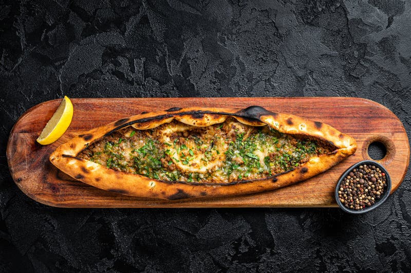 Turkish Pide Pie with Beef Meat and Vegetables. Black Background Stock ...