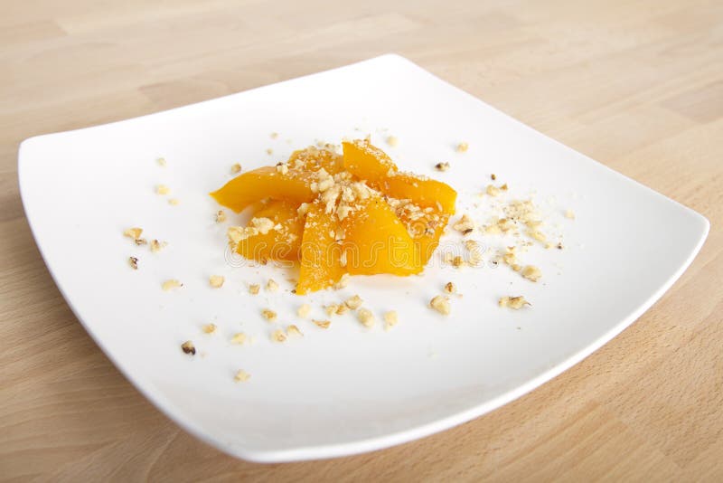 Pumpkin Dessert with Tahini and Walnuts on a Porcelain Plate Stock ...