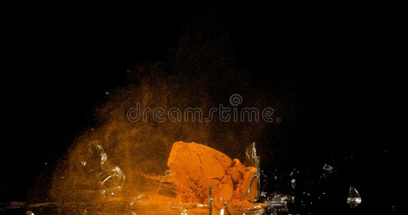 Turmeric, Curcuma Longa, Powder in a Small Jar Exploding Against Black ...