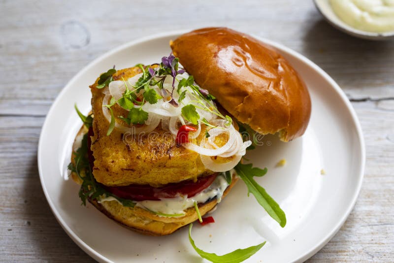 Cod fish burger stock photo. Image of plate, onion, fish - 187805542