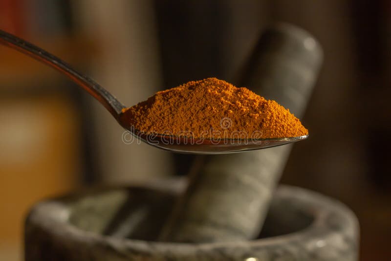 Ground Turmeric, upon Hovering Spoon, with Stone Mortar and Pestle in ...