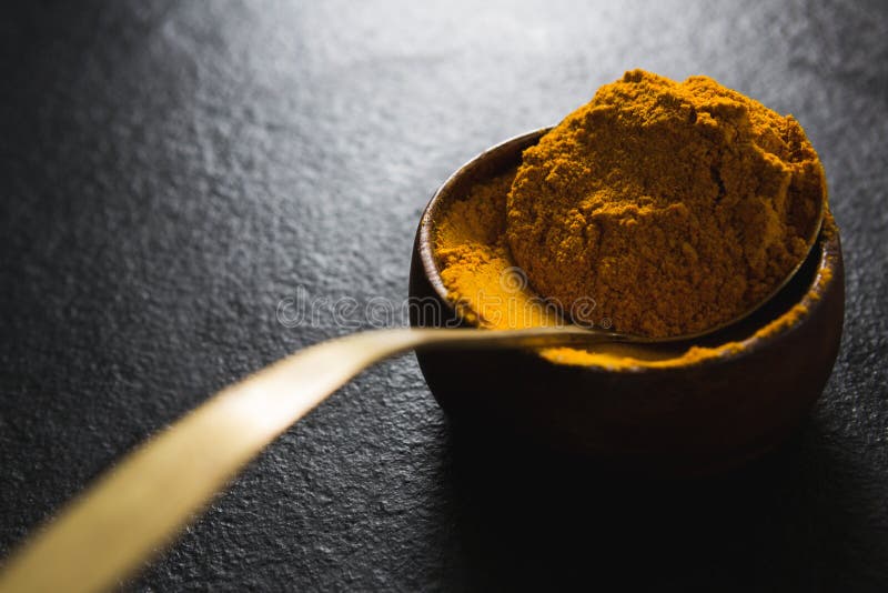 Turmeric powder in bowl stock photo. Image of edible - 99475234