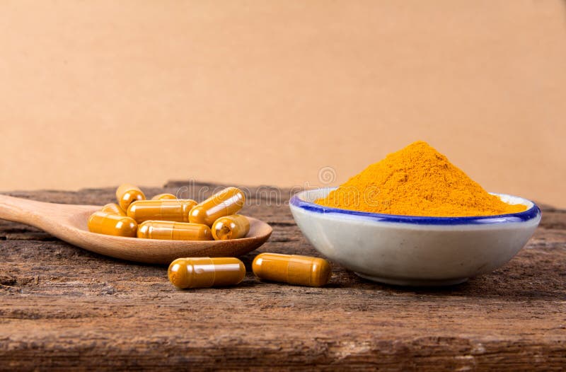 Turmeric Powder and Capsule and Roots Curcumin on Brown Paper Stock ...