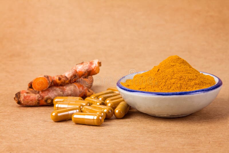 Turmeric Powder and Capsule and Roots Curcumin on Brown Paper Stock ...