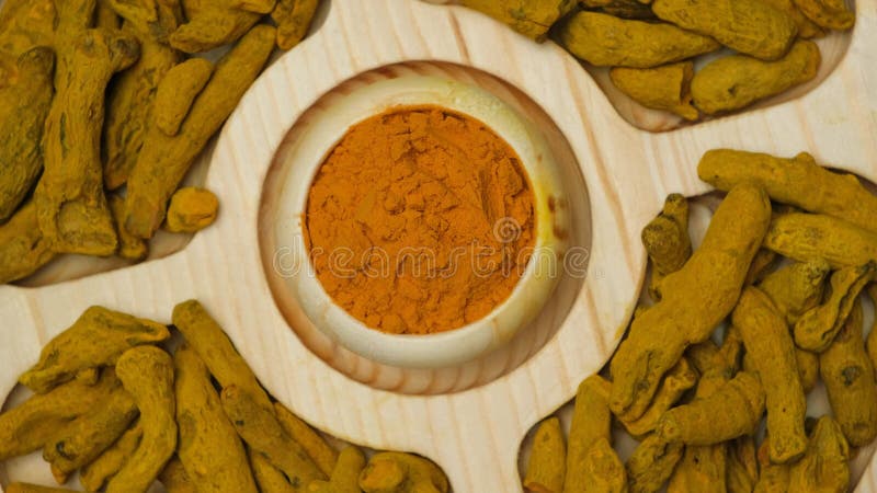 Turmeric Powder and Dried Turmeric Root in Motion Top View. Stock ...