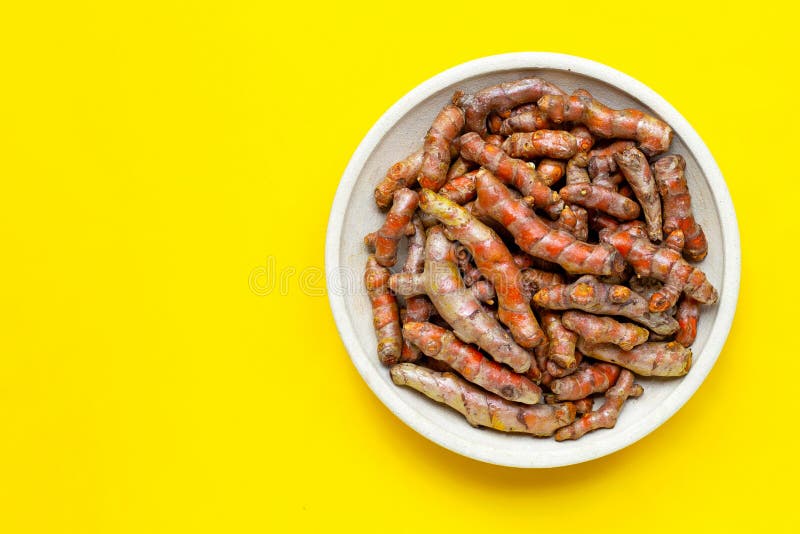 Turmeric Roots on Yellow Background Stock Image - Image of aromatic ...