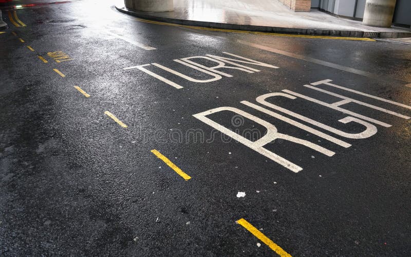 TURN RIGHT Sign / Text and Yellow Line on Wet Asphalt Road Stock Photo ...