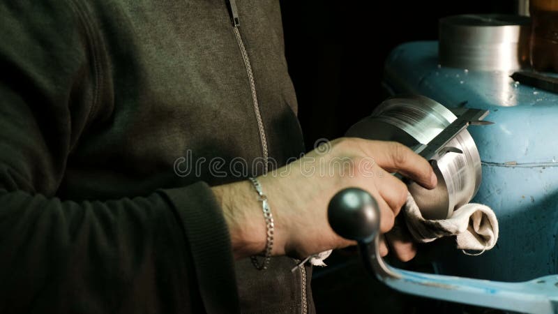 Turner Measures the Dimensions of the Metal Workpiece with a Caliper ...