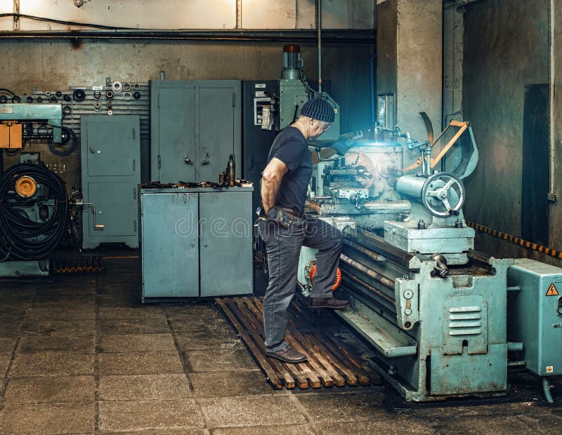 A Turner Processes a Metal Part on an Old Lathe. Stock Photo - Image of ...