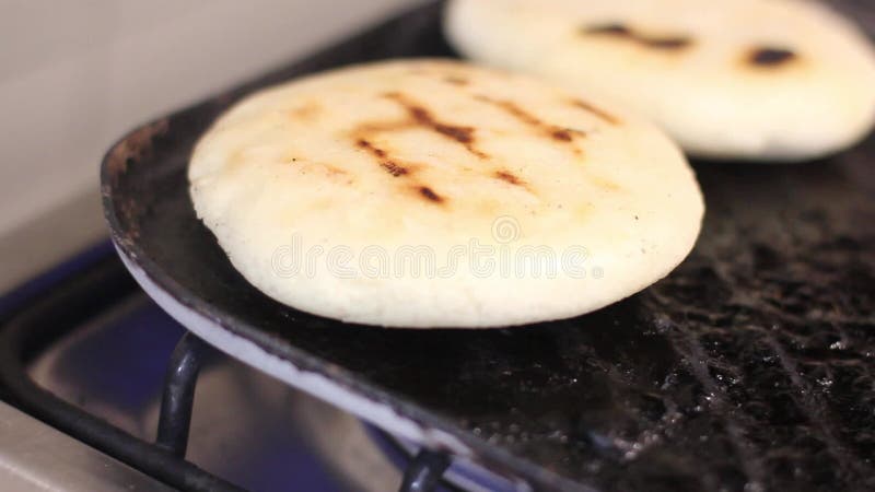 Turning the Corn Cake or Arepa Over the Hot Surface of the Cast Iron ...