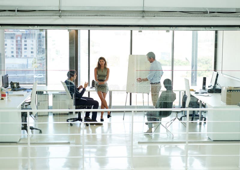 Turning an Idea into a Plan. a Group of Colleagues Brainstorming in an ...