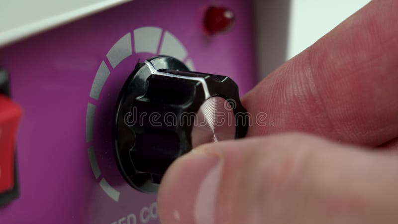 Turning the Power Knob on the Pink Panel of the Electrical Appliance ...