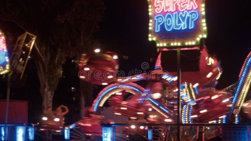 The Turning Roundabout at Night in an Amusement Park Stock Footage ...