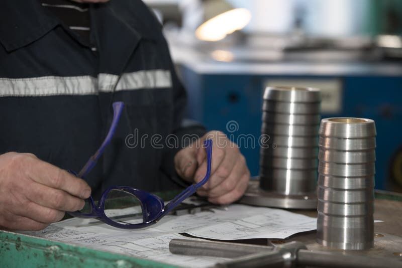 Turning Shop or Production. Worker`s Hands Hold a Metal Stock Image ...