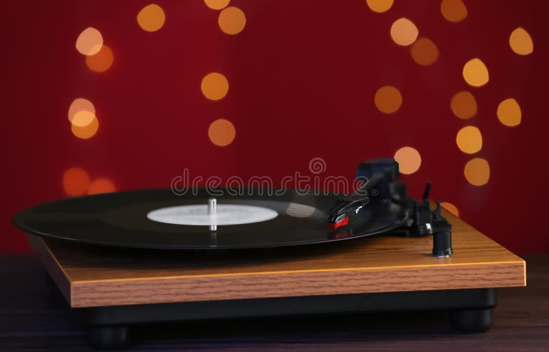 Turntable with Vinyl Record Against Blurred Lights. Space for Text ...