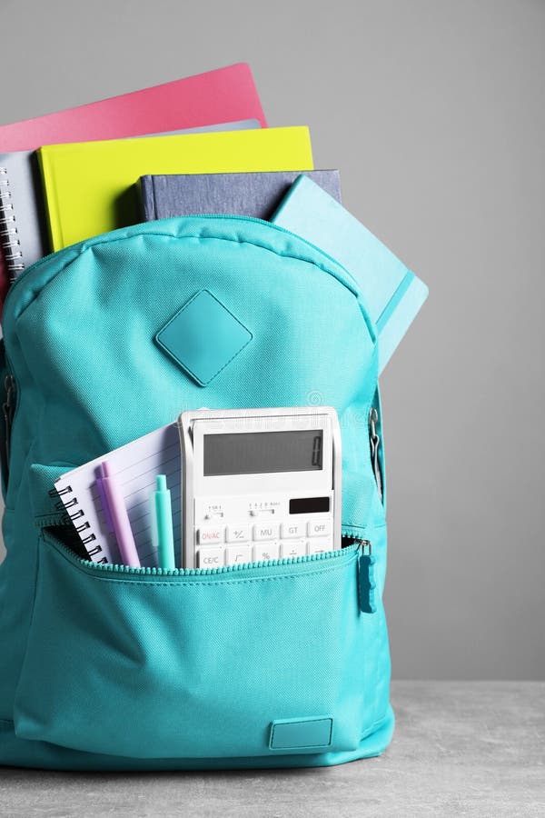 Turquoise Backpack and Different School Stationery on Table Against ...