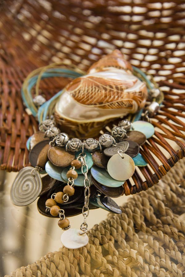 Turquoise Blue Necklace and Rapans Over Straw Basket Stock Image ...