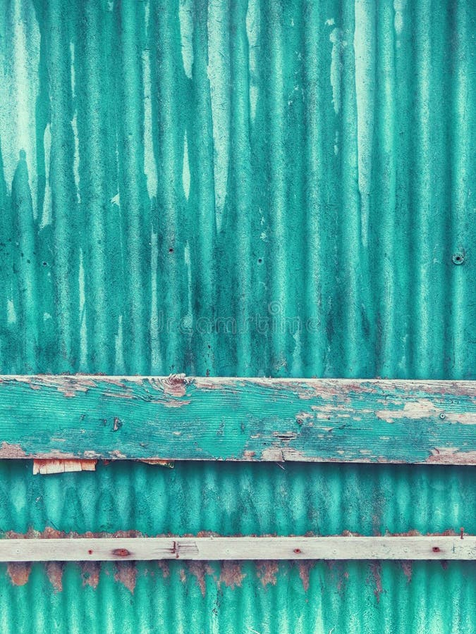 Turquoise-colored Metal Wall with a Wooden Plank Fixed on it Stock ...