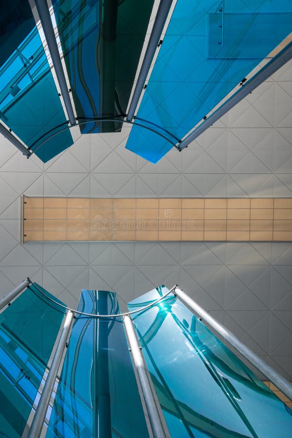 Turquoise Glass Panes Rising Up Towards a Grey Panel Ceiling Stock ...