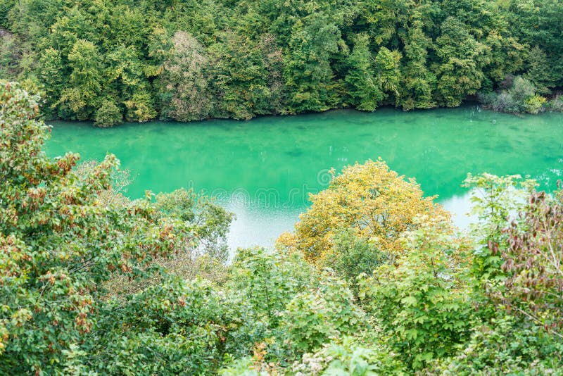 A Turquoise Lake in Mountainous Terrain Surrounded by Forest. Stock ...