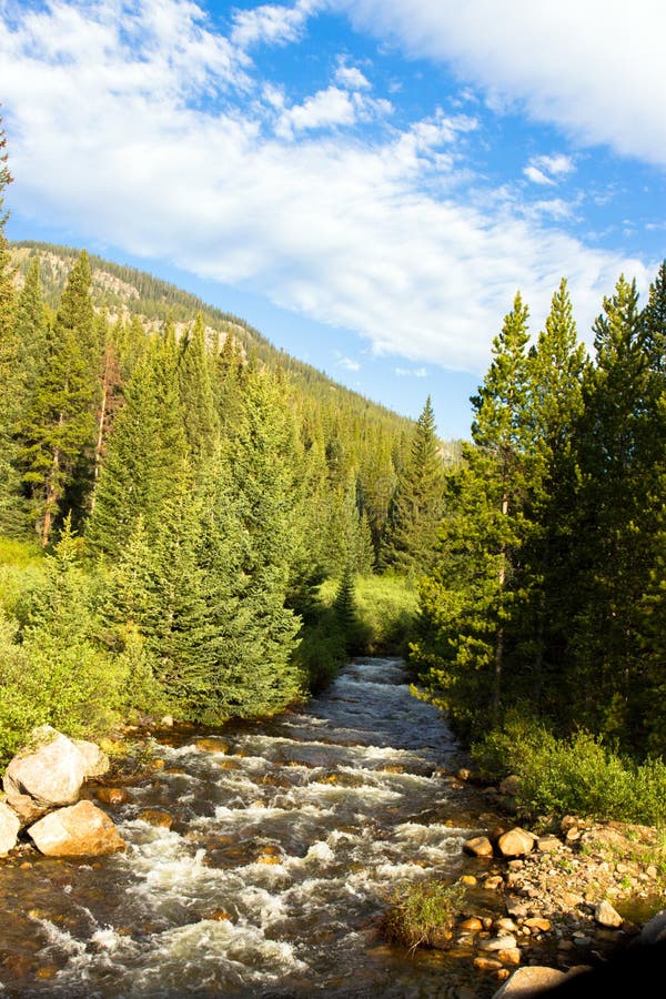 A Stream Flows Over Rocks Toward Turquoise Lake Stock Image - Image of ...