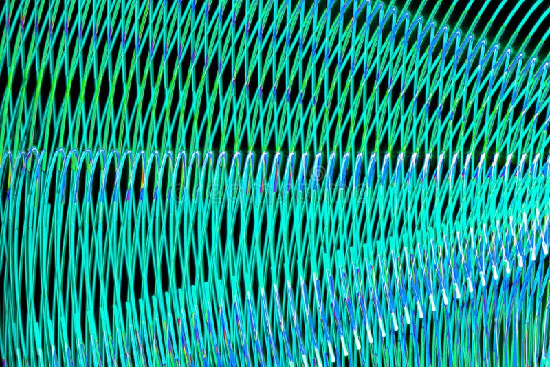 Turquoise Neon Light Lines in the Dark Green Leaves. Stock Image ...