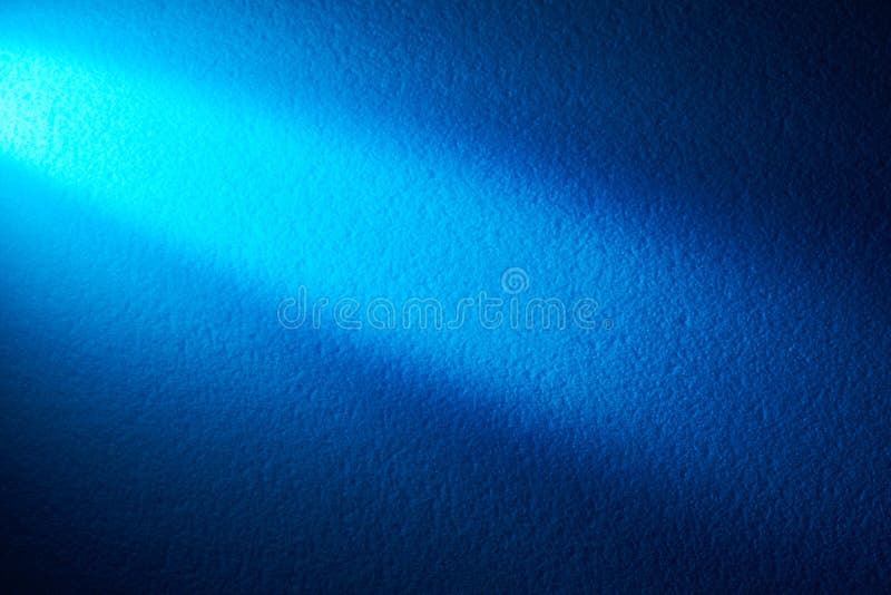 A Turquoise Ray Cuts Diagonally through a Blue Texture Background Stock ...