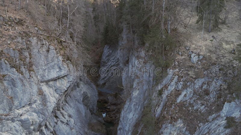 A Turquoise River Flows through a Deep Rocky Gorge Surrounded by Steep ...