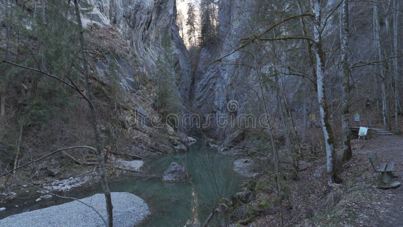 A Turquoise River Flows through a Deep Rocky Gorge Surrounded by Steep ...