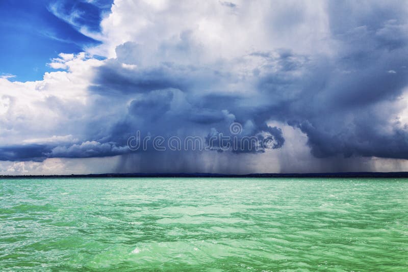 Turquoise Sea and Dramatic Dark Sky with Clouds, Beautiful Landscape ...
