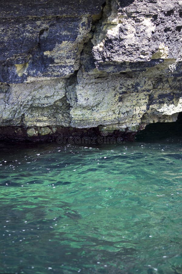 Turquoise Sea and Rocky Cliff. Vertical Photo Stock Photo - Image of ...
