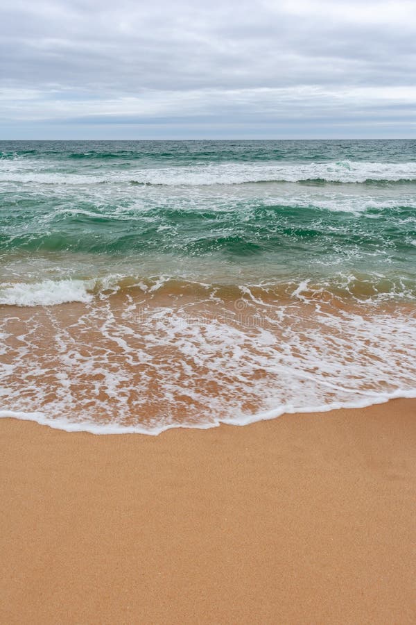 Turquoise Sea with Waves and Sea Foam, Sandy Beach Stock Photo - Image ...