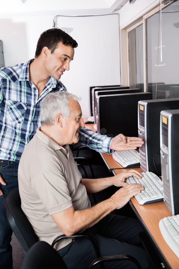 Tutor Assisting Senior Man In Using Computer Stock Image Image Of