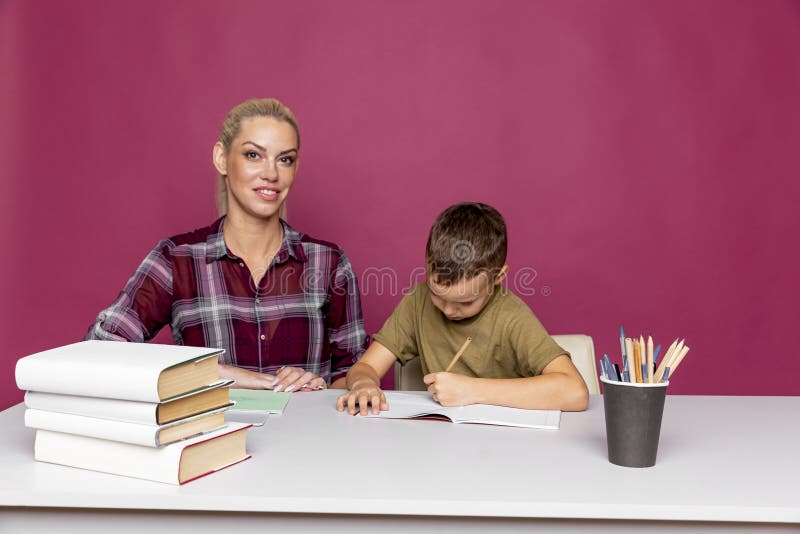 Tutor with Child Doing Homework Together in the Pink Room. Stock Photo ...